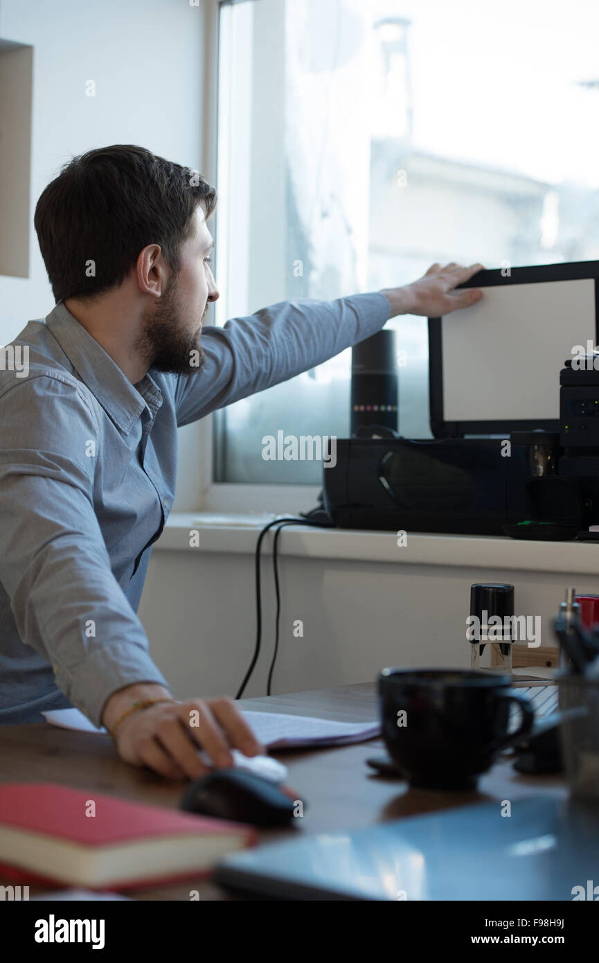 Handsome businessman scanning and printing document in office Stock ...