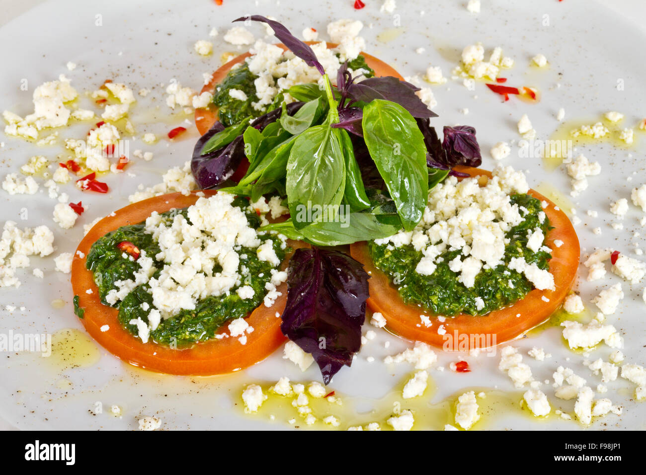 appetizer with tomato,cheese and pesto Stock Photo - Alamy
