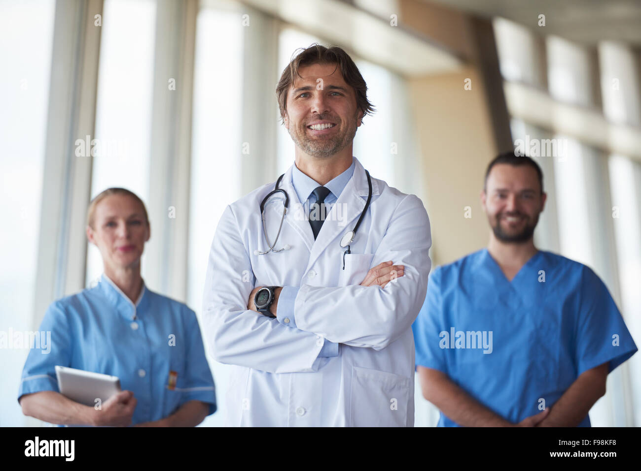 group of medical staff at hospital, handsome doctor in front of team ...