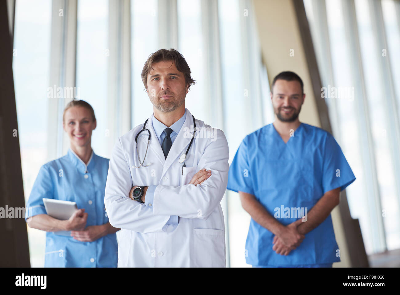 group of medical staff at hospital, handsome doctor in front of team ...