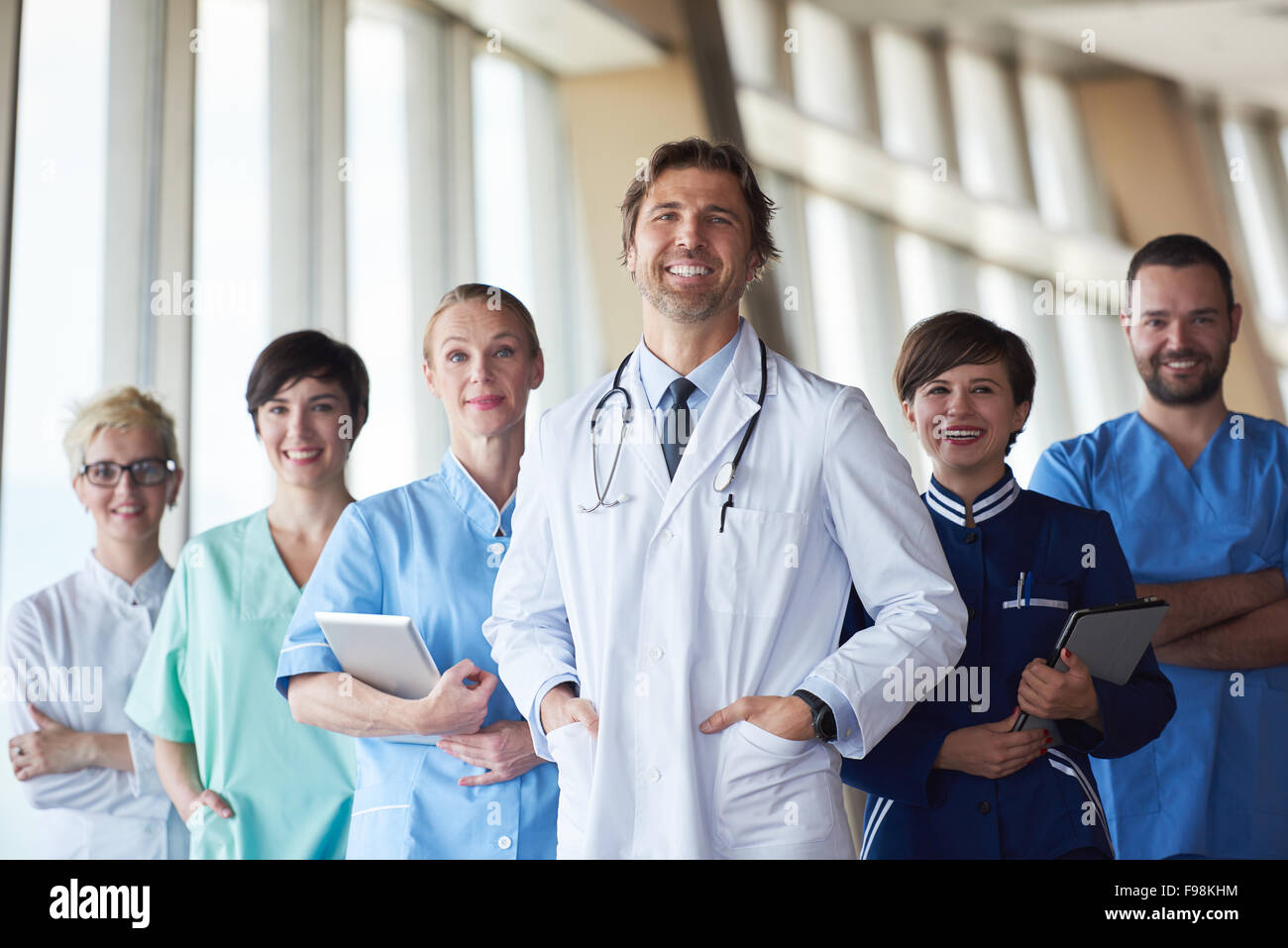 group of medical staff at hospital, handsome doctor in front of team ...