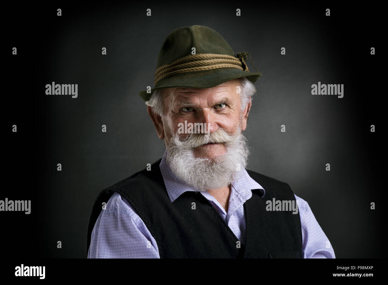 Portrait of old bearded bavarian man in traditional felt hat, posing in ...