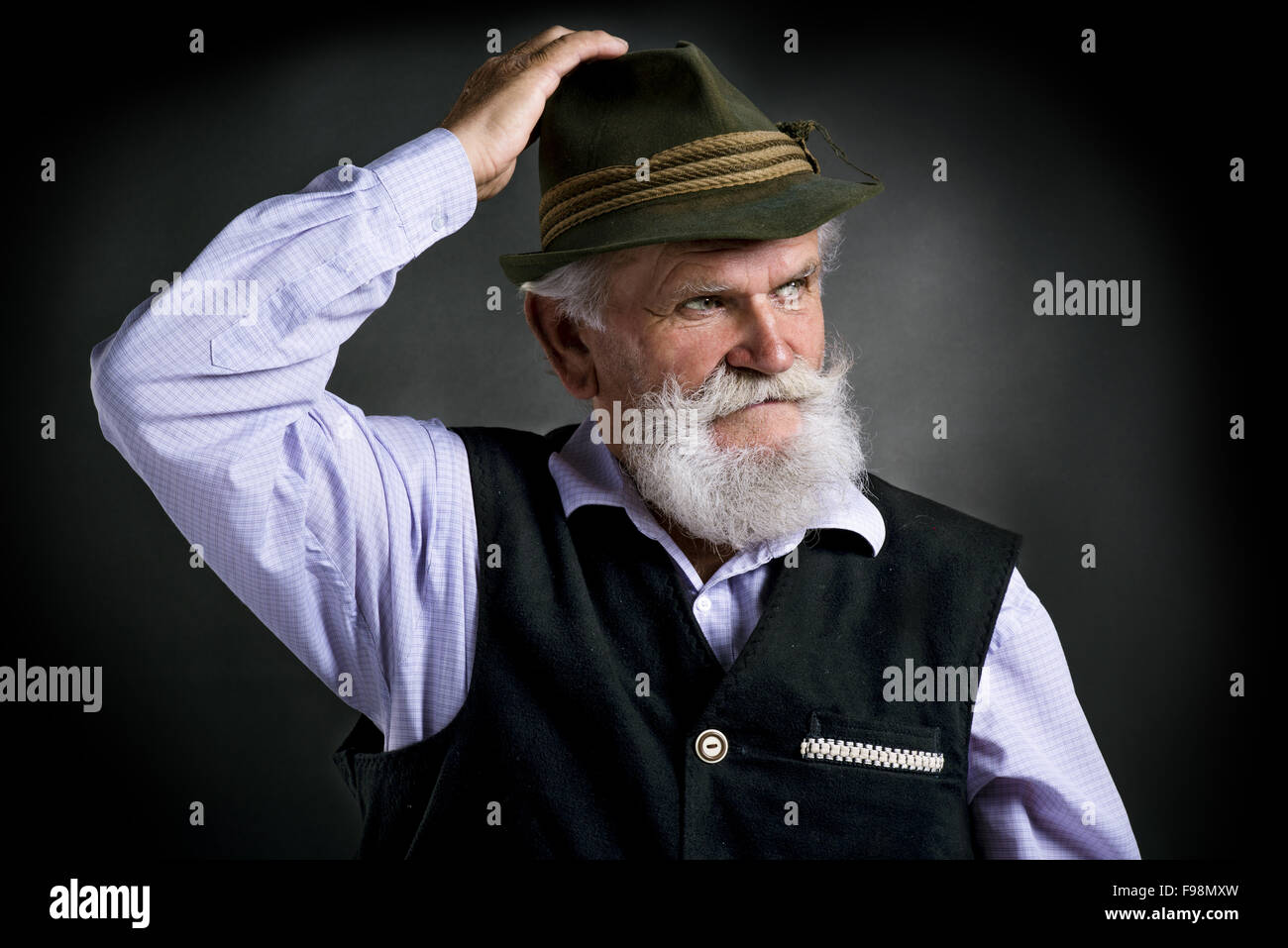 Portrait of old bearded bavarian man in traditional felt hat, posing in ...