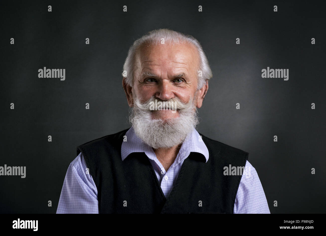 Portrait of old bearded man, posing in studio on black background Stock ...
