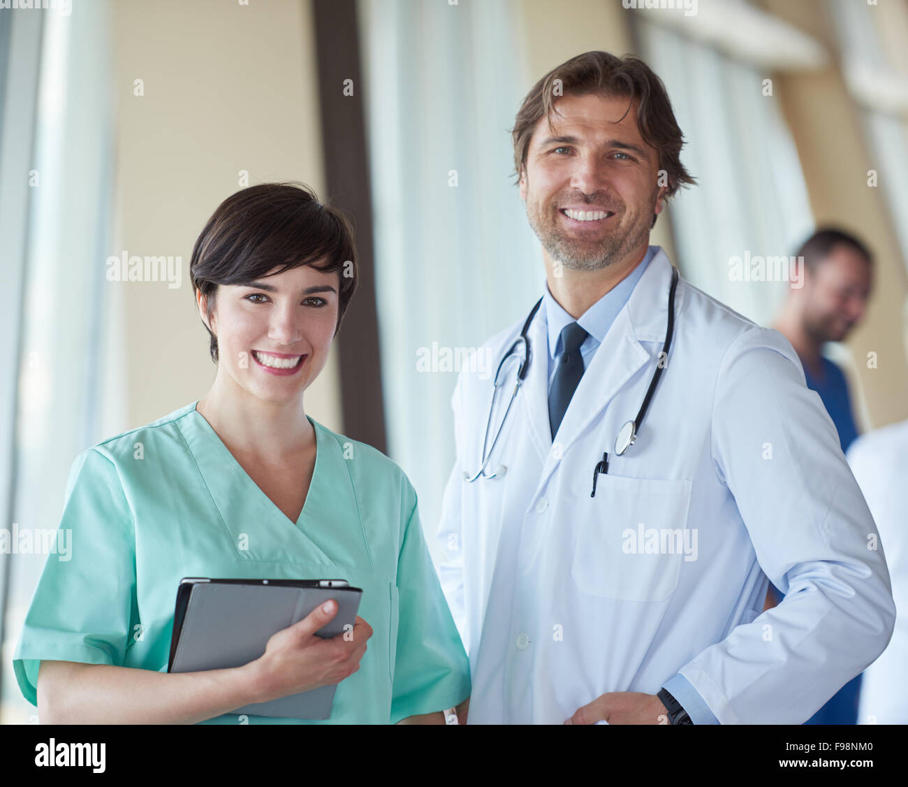 group of medical staff at hospital, handsome doctor in front of team ...