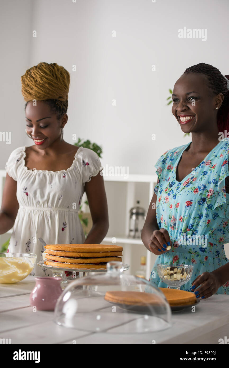 Young african women at the kitchen cooking cake with strawberry Stock ...