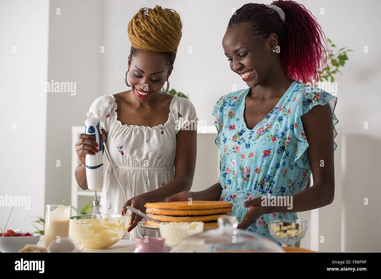 Young african women at the kitchen cooking cake with strawberry Stock ...