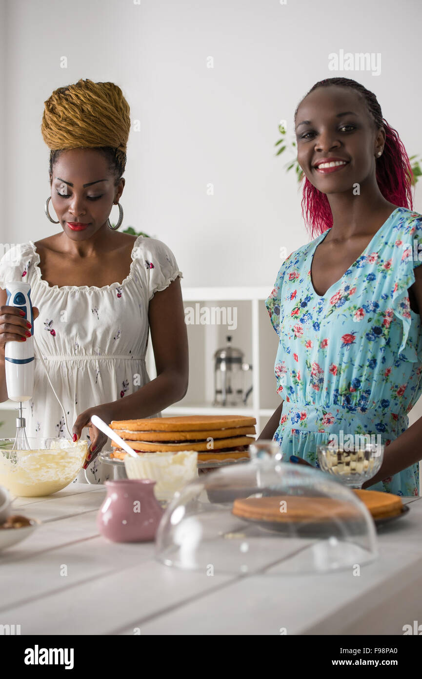 Young african women at the kitchen cooking cake with strawberry Stock ...