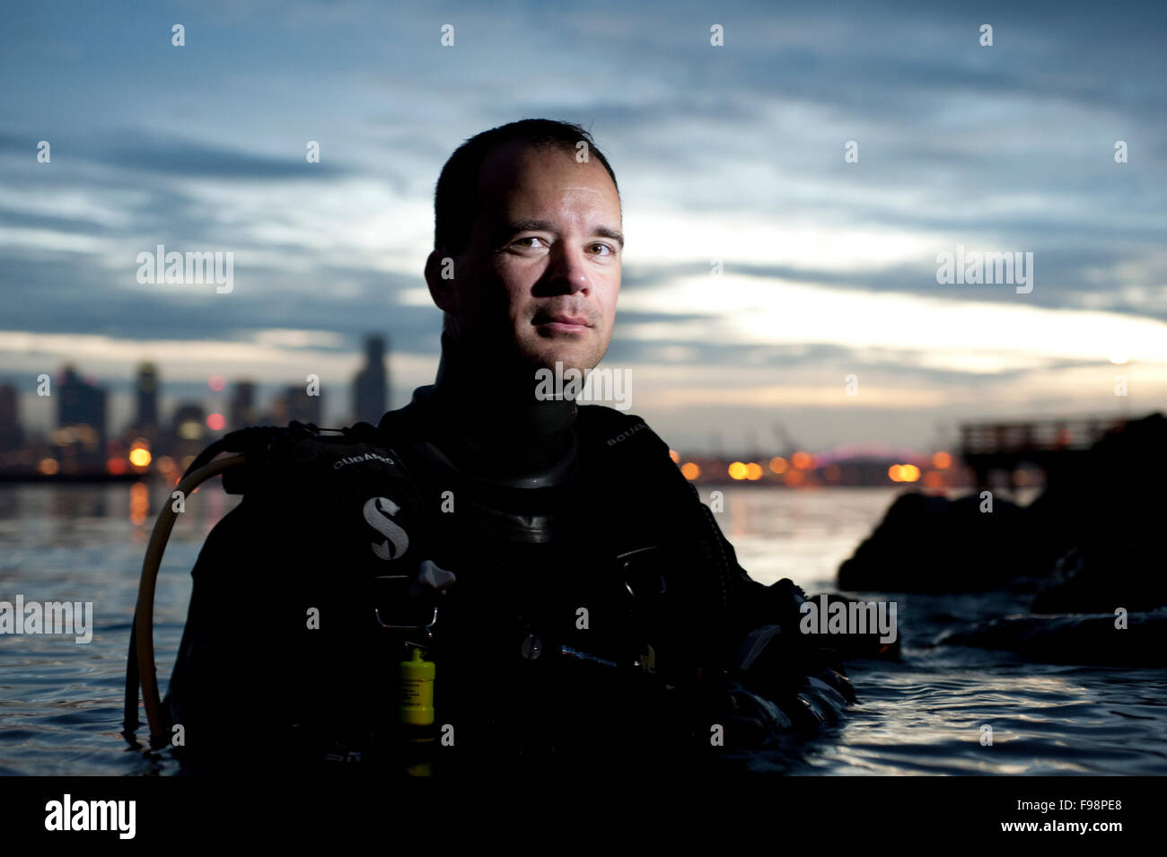 Scuba diver portrait with city background Stock Photo - Alamy