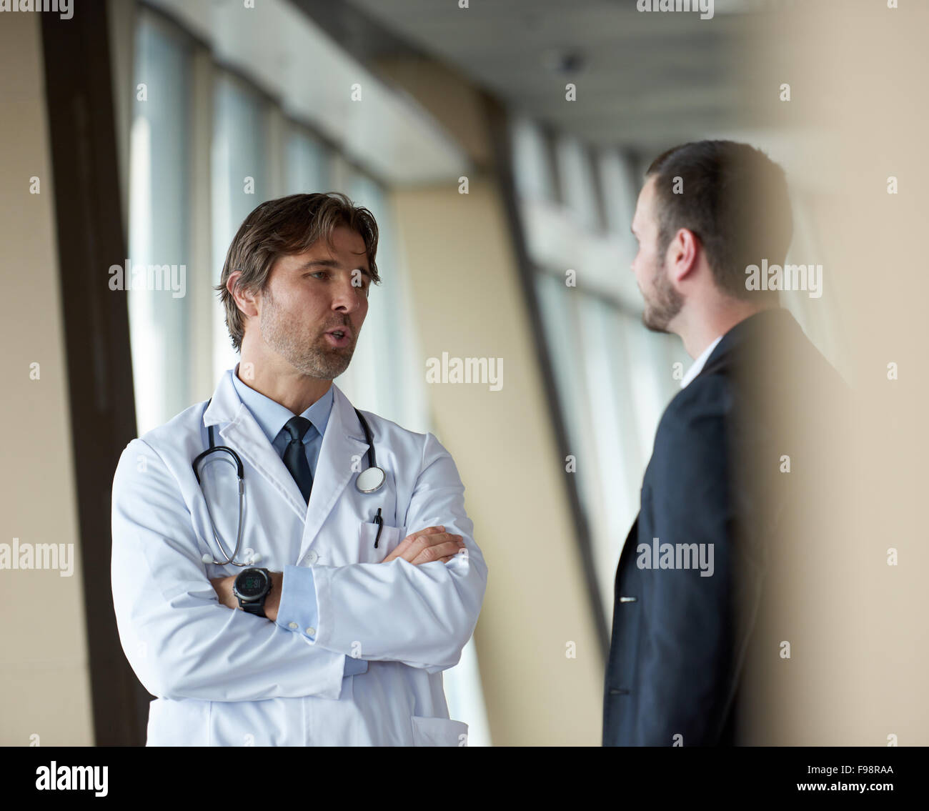 doctor handshake with a patient at doctors bright modern office in ...