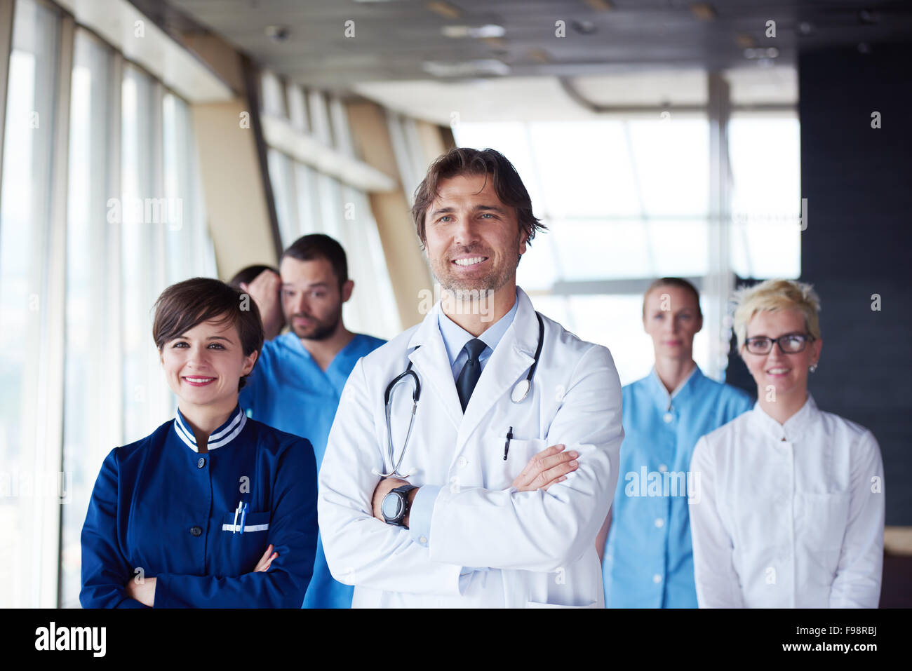 doctors team walking in modern hospital corridor indoors, poeople group ...