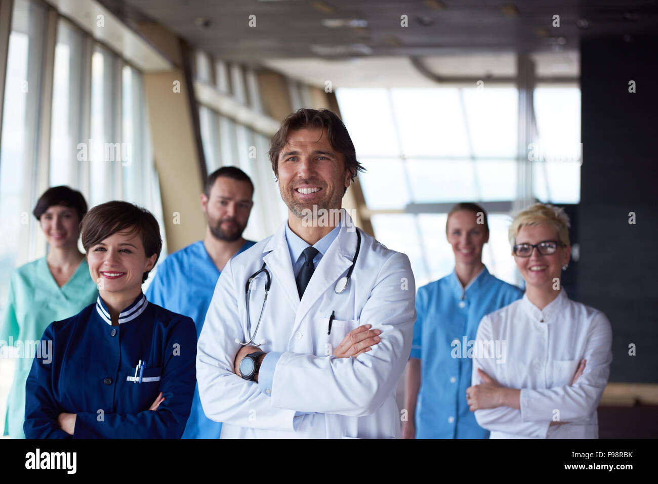 doctors team walking in modern hospital corridor indoors, poeople group ...