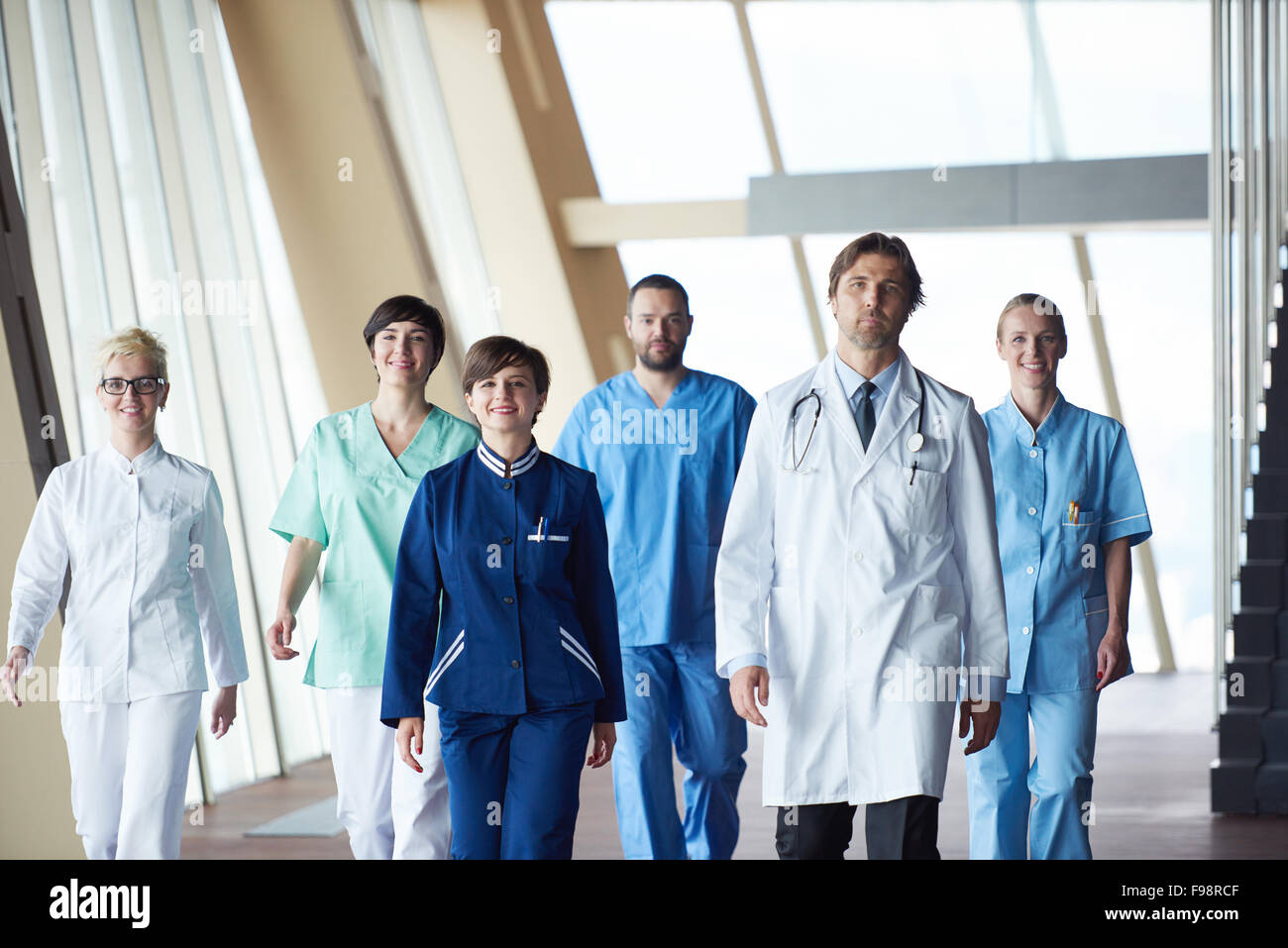 doctors team walking in modern hospital corridor indoors, poeople group ...