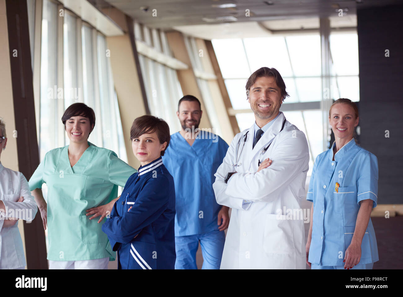 doctors team walking in modern hospital corridor indoors, poeople group ...