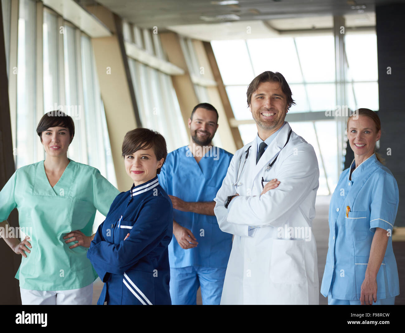 doctors team walking in modern hospital corridor indoors, poeople group ...