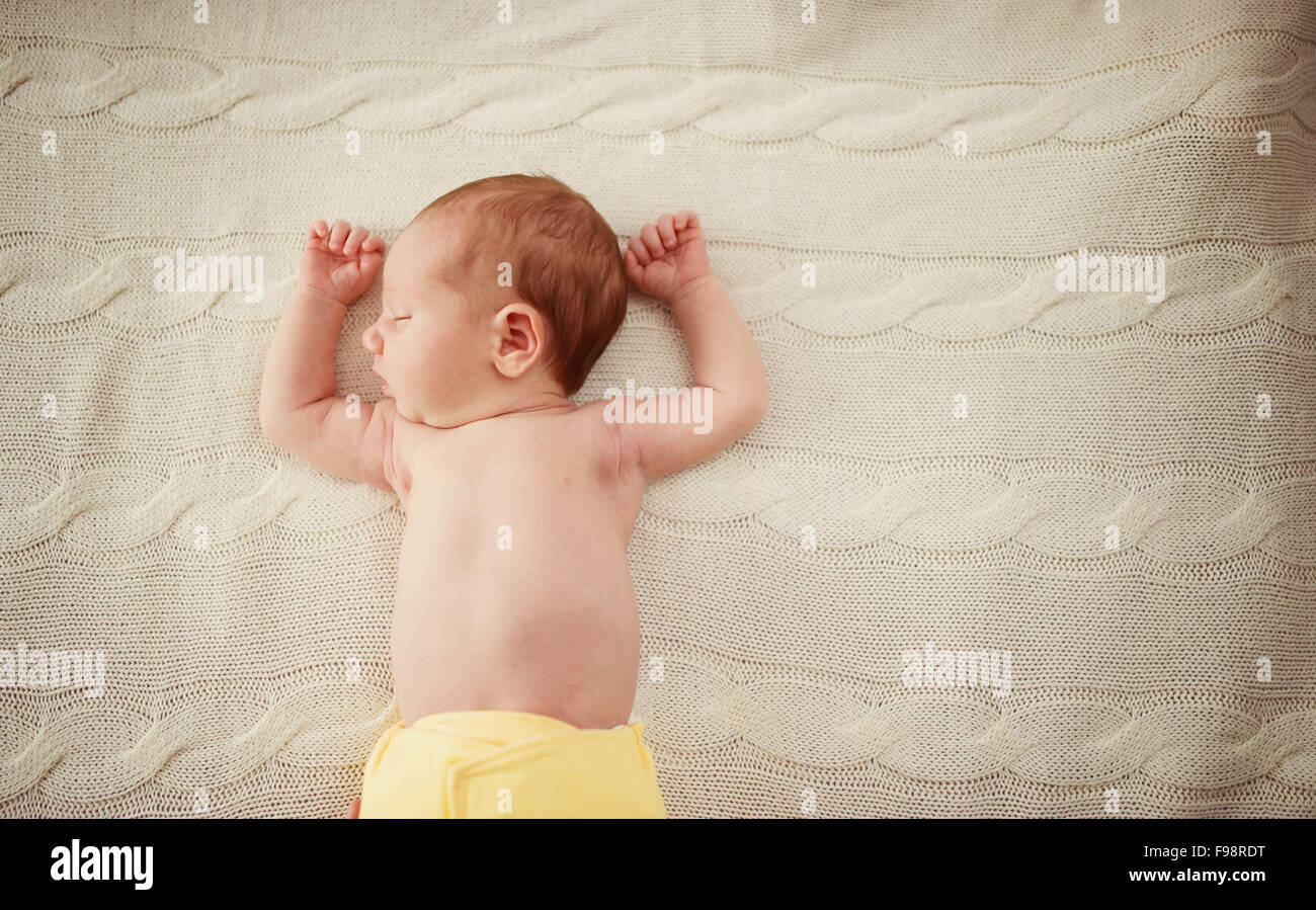 Cute newborn baby girl sleeping in bed at home Stock Photo - Alamy