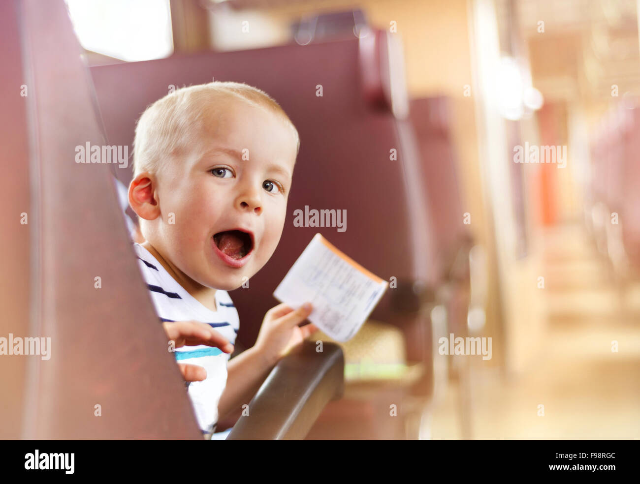 Boy travelling in retro train. He is holding train ticket Stock Photo ...