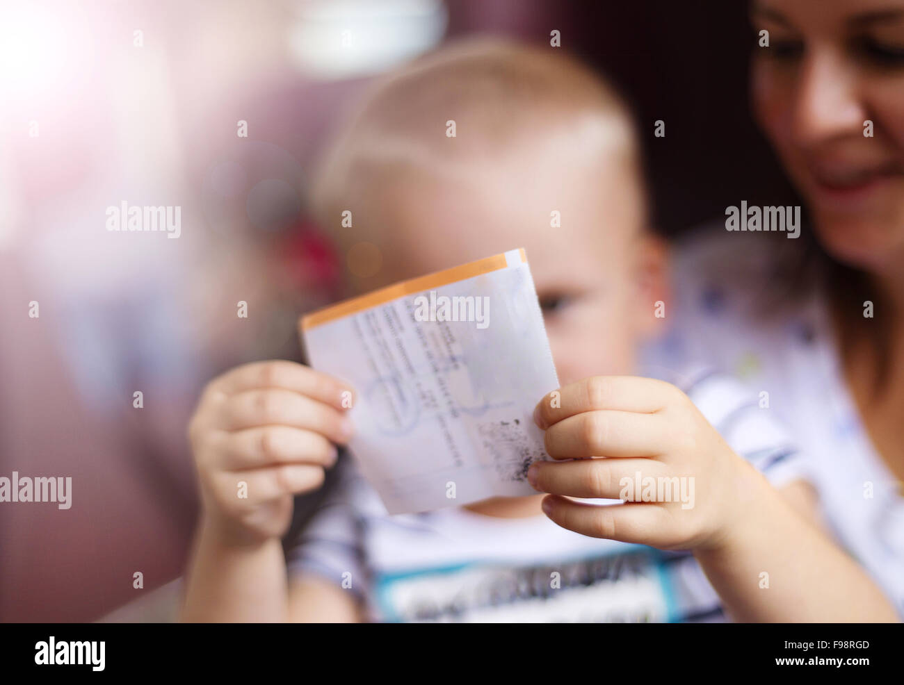 Boy travelling in retro train. He is holding train ticket Stock Photo ...
