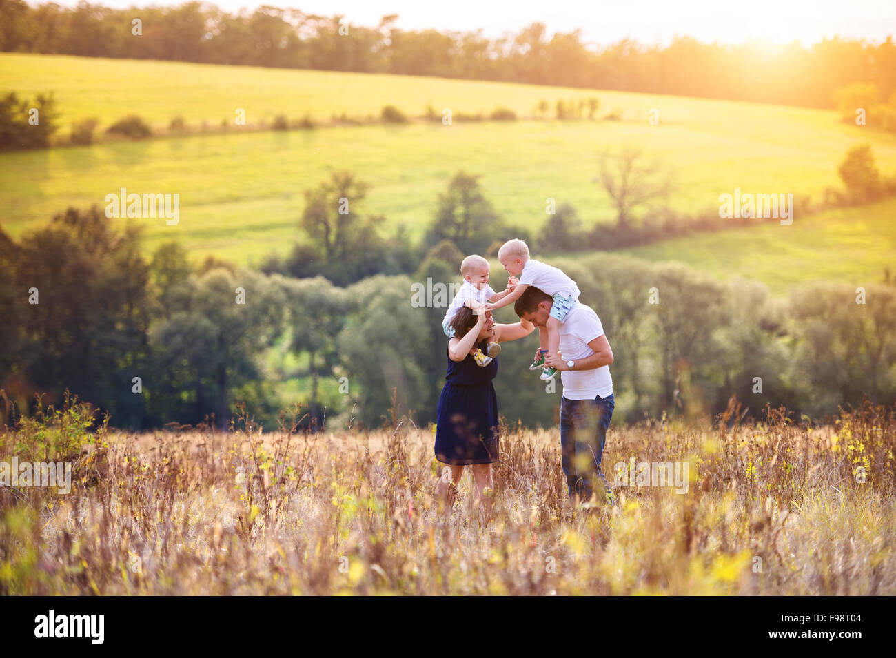 Happy family enjoying life together at meadow outdoor Stock Photo - Alamy