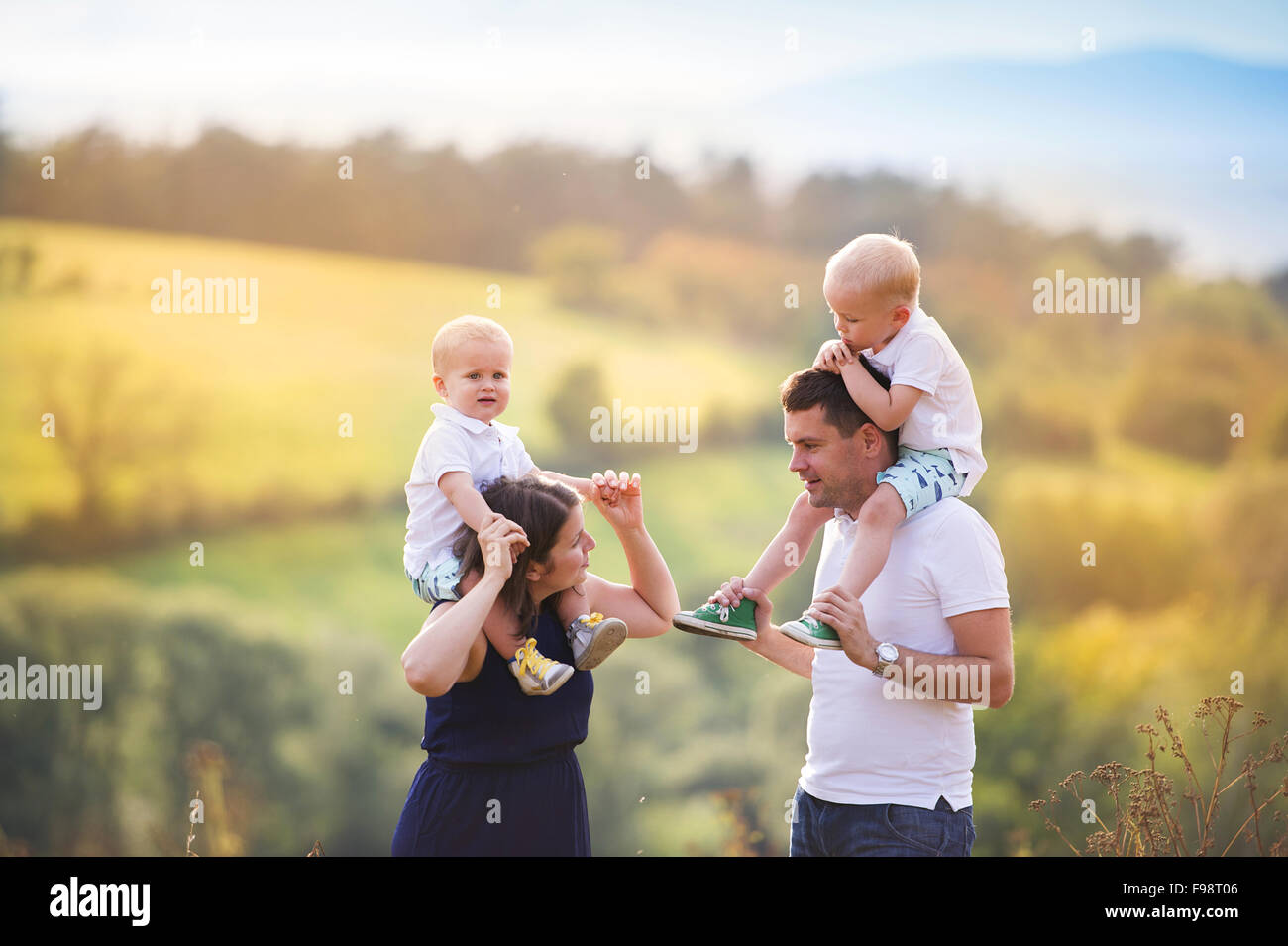 Happy family enjoying life together at meadow outdoor Stock Photo - Alamy