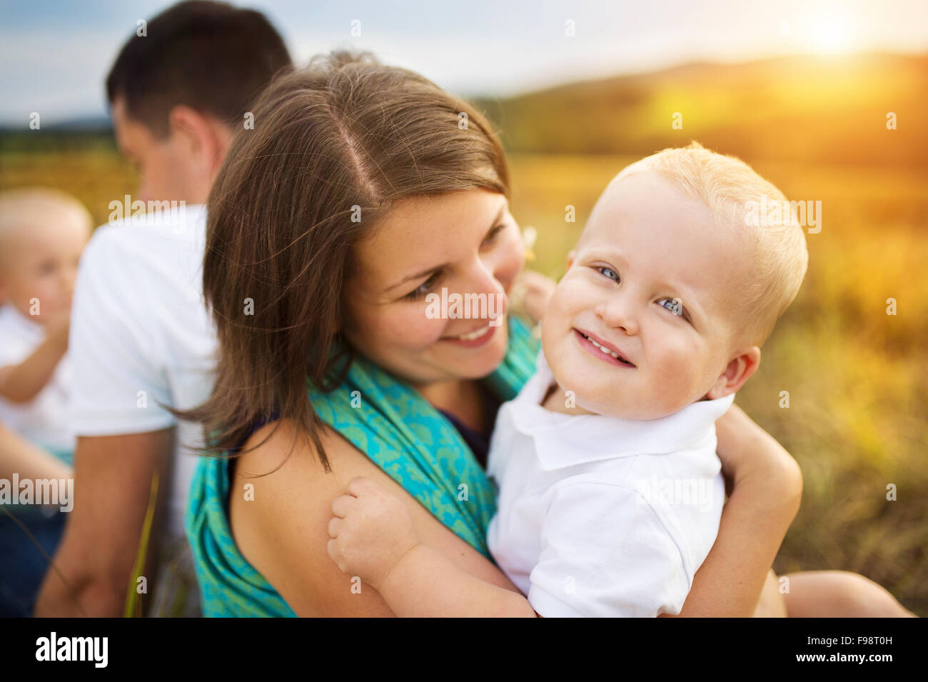 Happy family enjoying life together at meadow outdoor Stock Photo - Alamy