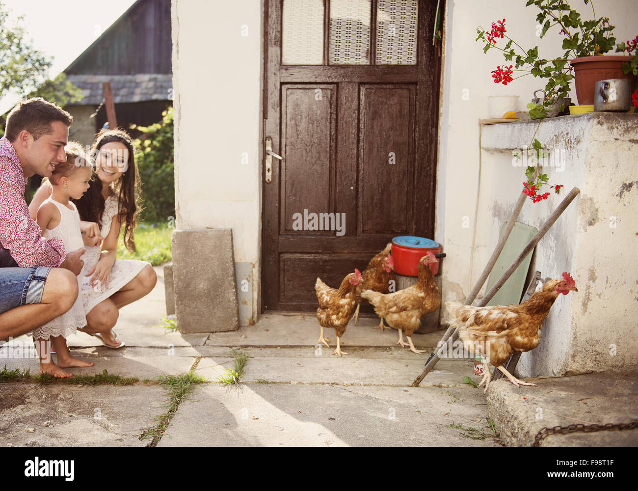 Happy family having fun in garden near the old farmhouse Stock Photo ...