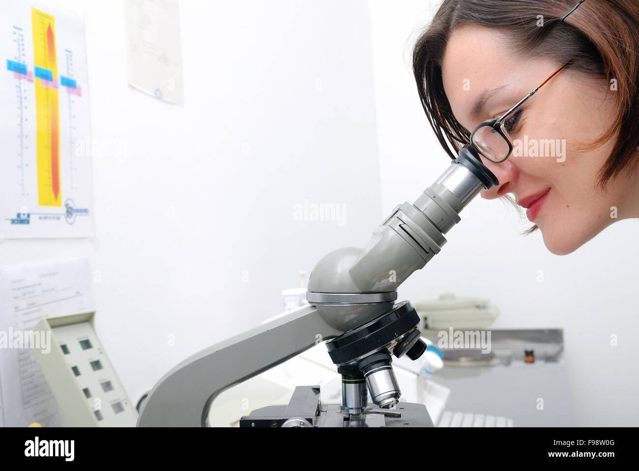 young woman looking on microscope Stock Photo - Alamy