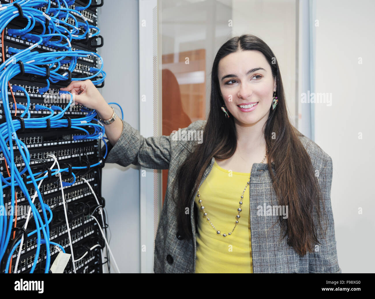 woman it engineer in network server room solving problems and give help ...