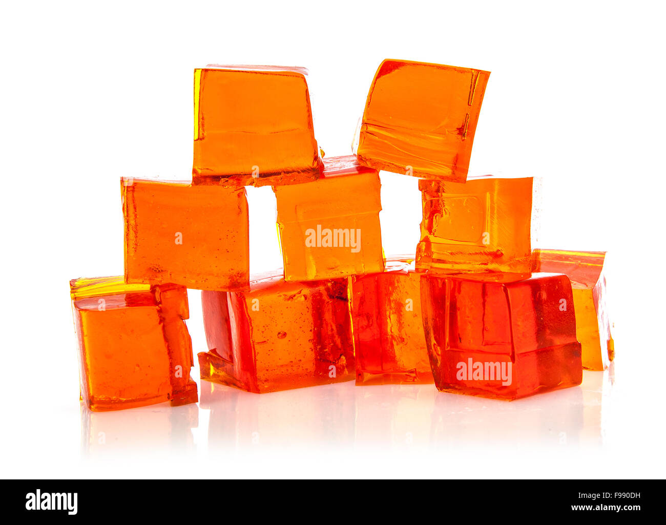 Orange jelly cubes on white background Stock Photo - Alamy