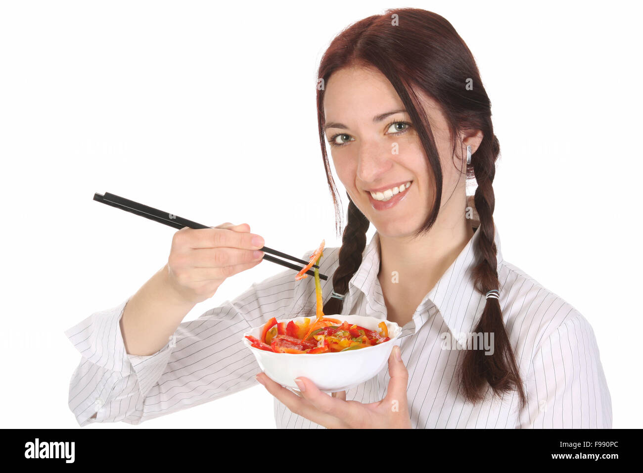Beautiful woman eating with chopsticks Stock Photo - Alamy