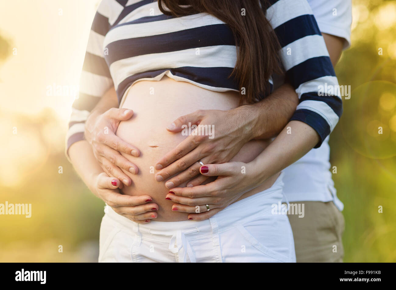 Pregnant holding hands hi-res stock photography and images - Alamy