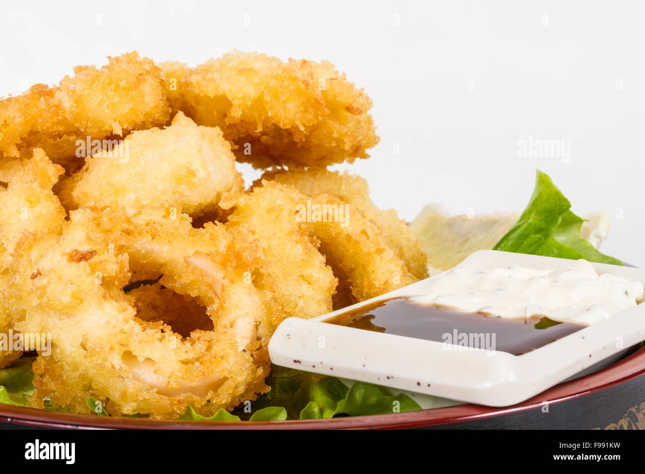 Deep batter fried squid rings calamari with green salad Stock Photo - Alamy