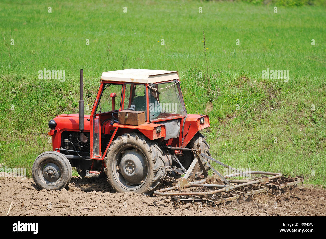 tractor trails with ground and grass background representing ...