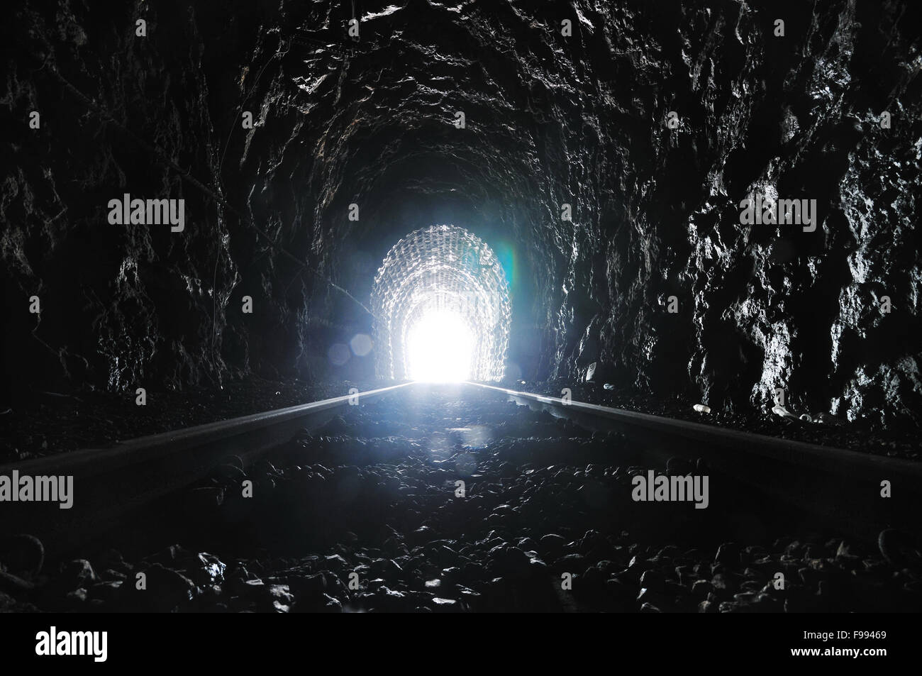 light on end of train tunnel representing new life and success concept ...