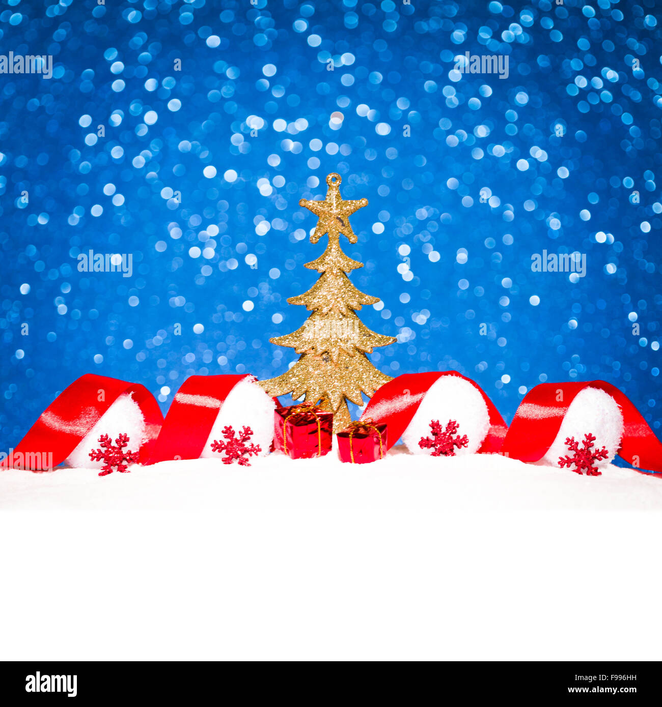 christmas tree in snow on glitter background Stock Photo - Alamy