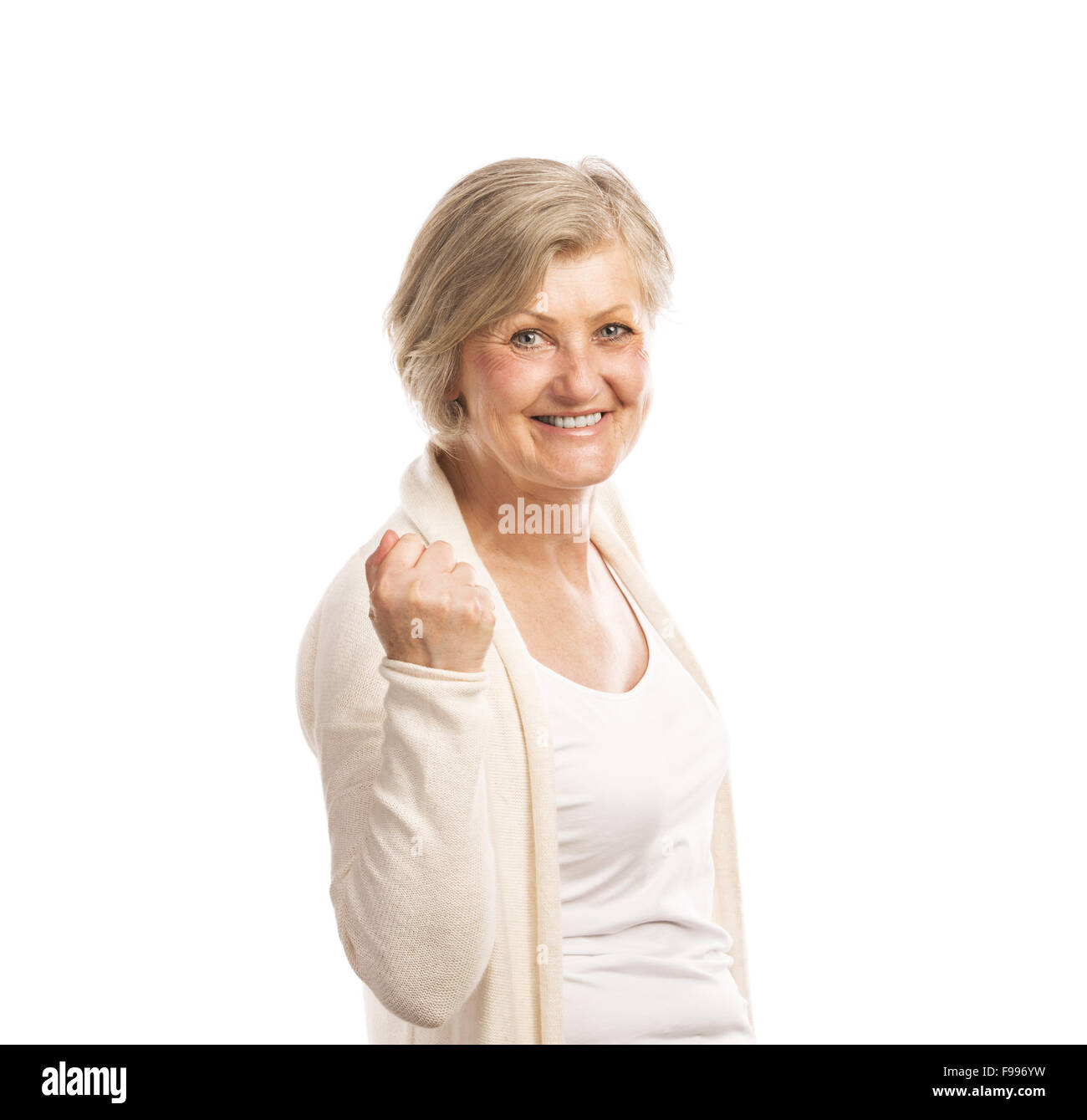Portrait of a happy senior woman saying yes and gesturing while ...
