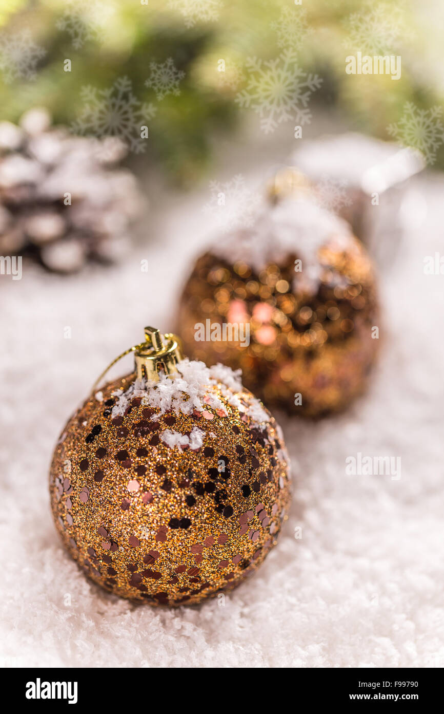 Gilded Christmas balls in the snow Stock Photo - Alamy