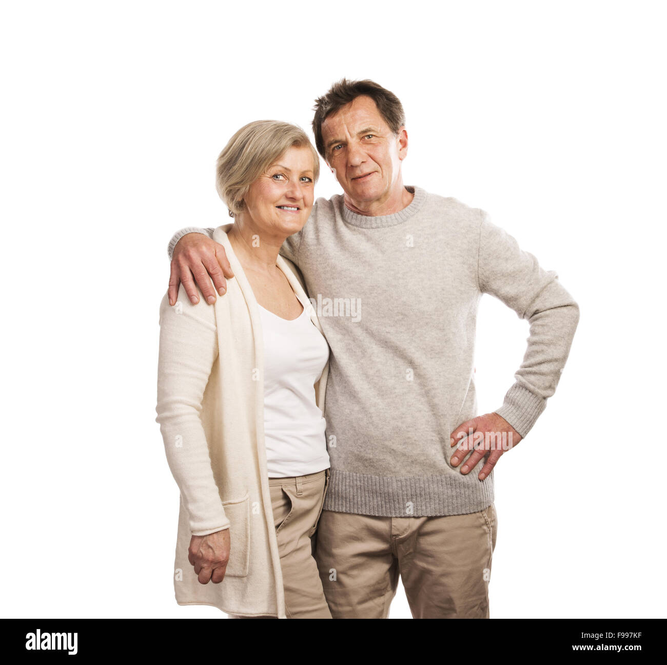 Studio portrait of happy seniors couple hugging. Isolated on white ...