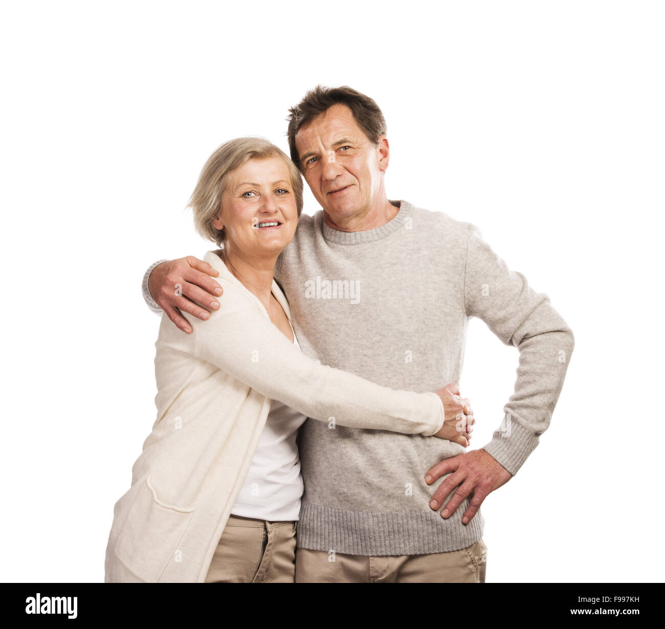 Studio portrait of happy seniors couple hugging. Isolated on white ...