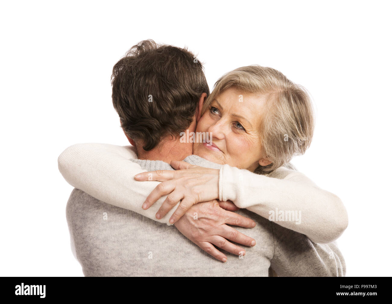 Studio portrait of happy seniors couple hugging. Isolated on white ...