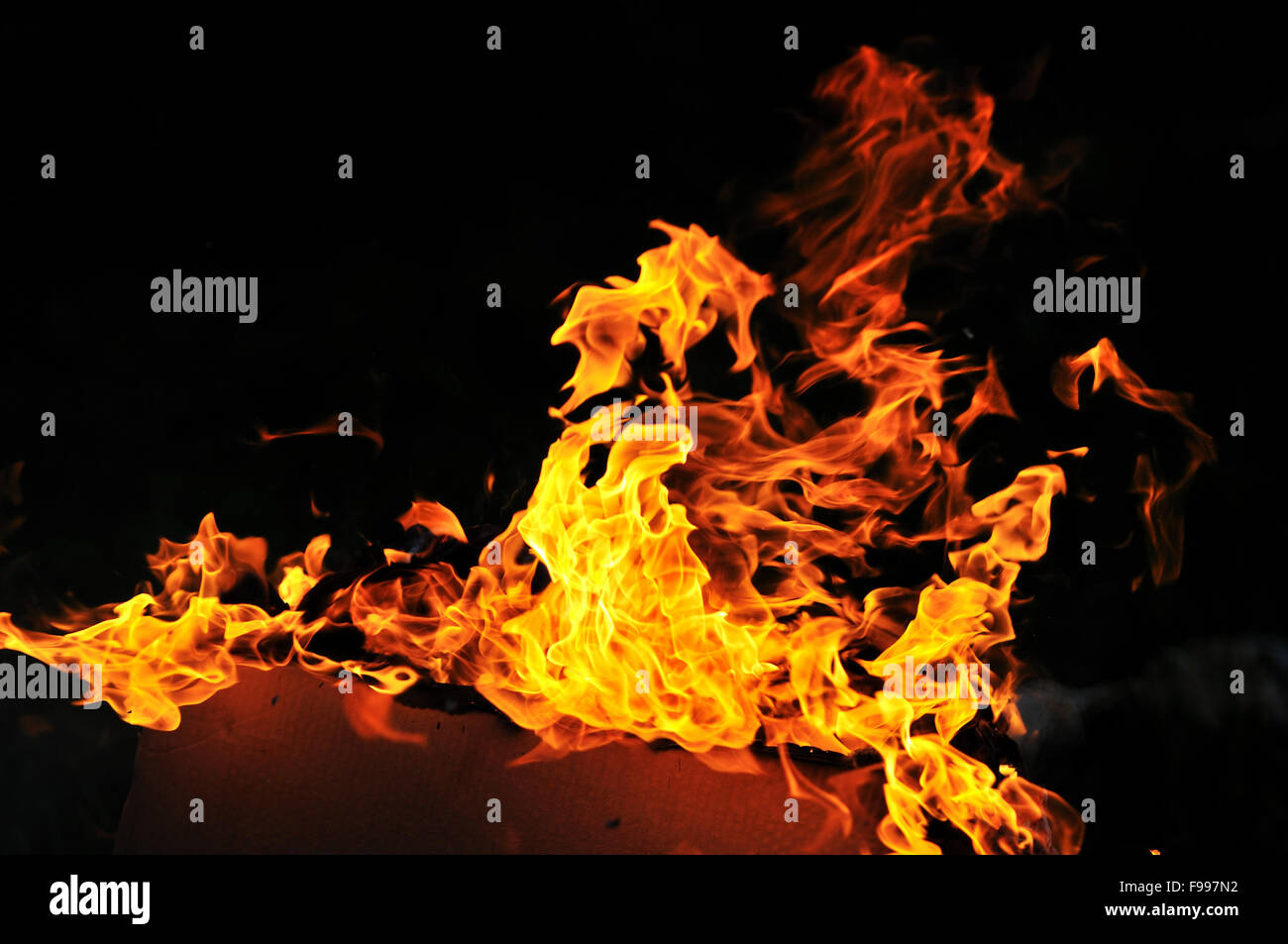 wild fire flames burn hot with black background Stock Photo - Alamy