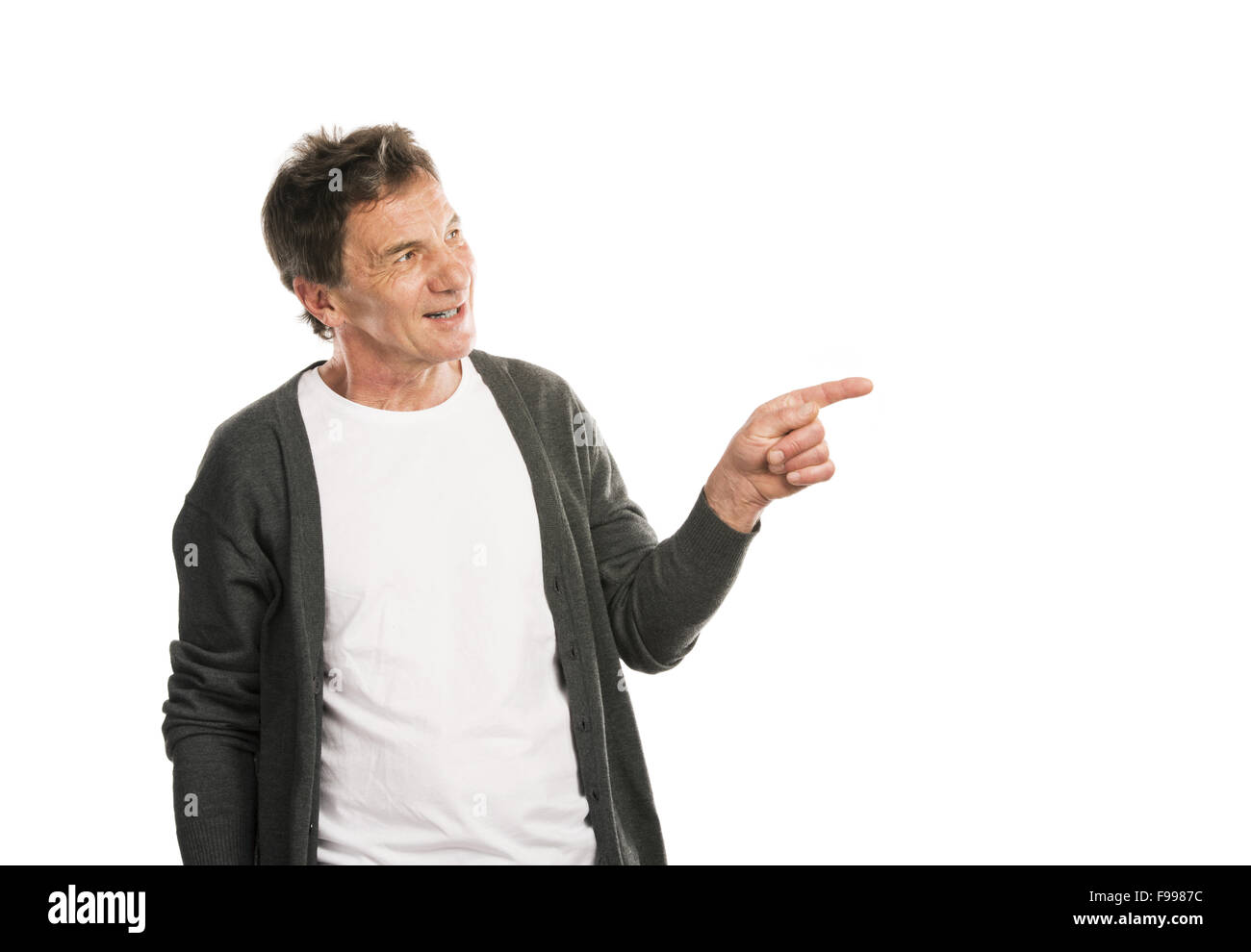 Portrait of a happy senior man pointing somewhere isolated on white ...