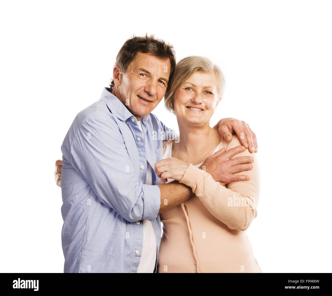 Studio portrait of happy seniors couple hugging. Isolated on white ...