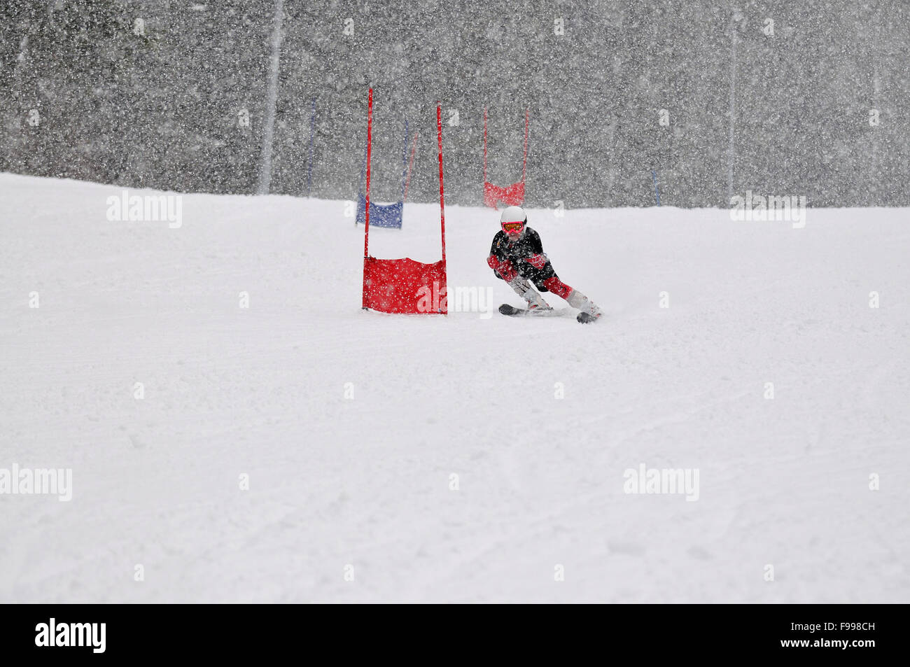 young skier race fast downhil at winter snow scene Stock Photo - Alamy