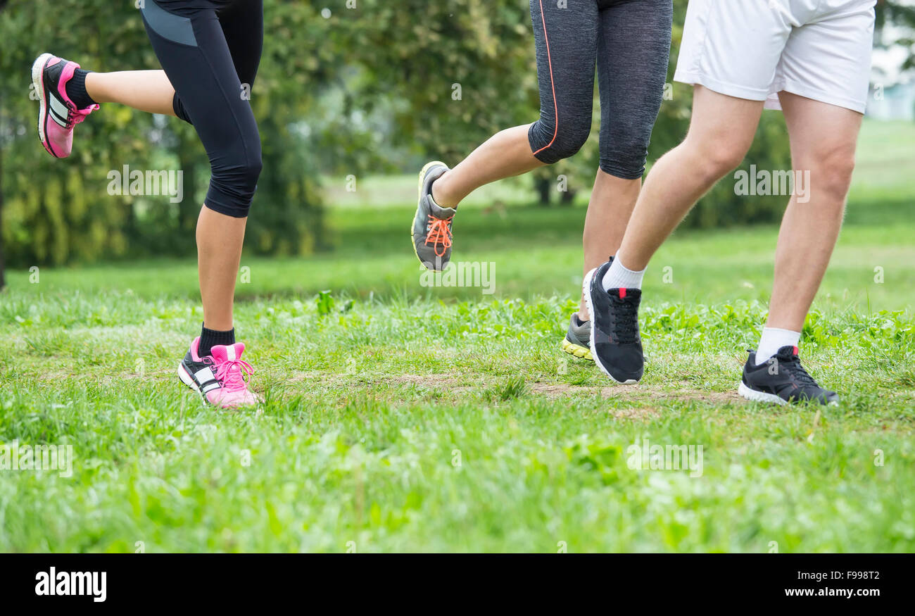 Young people running in the park Stock Photo - Alamy