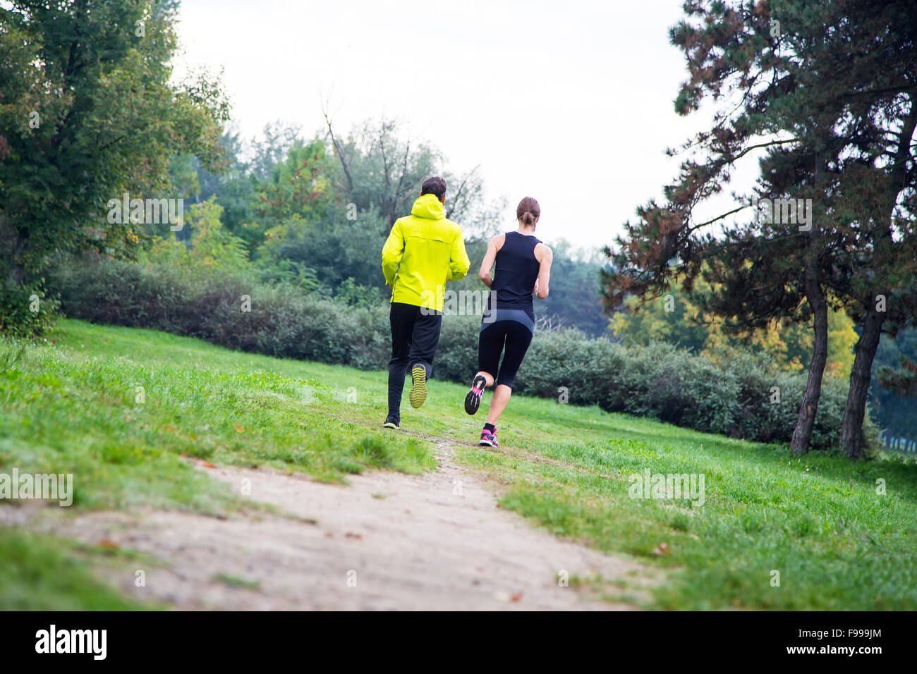 Young people running in the park Stock Photo - Alamy