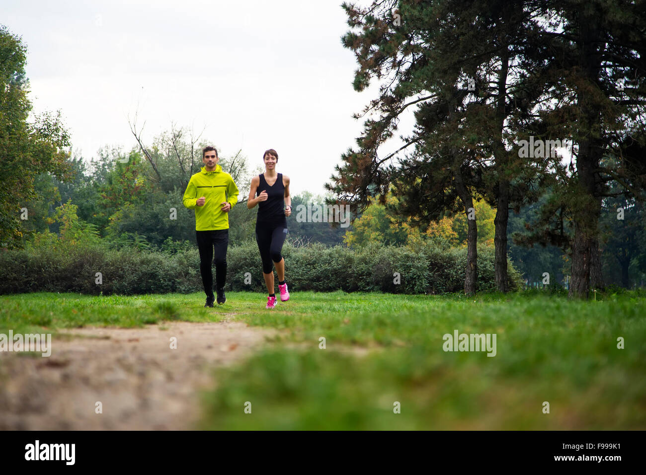 Young people running in the park Stock Photo - Alamy
