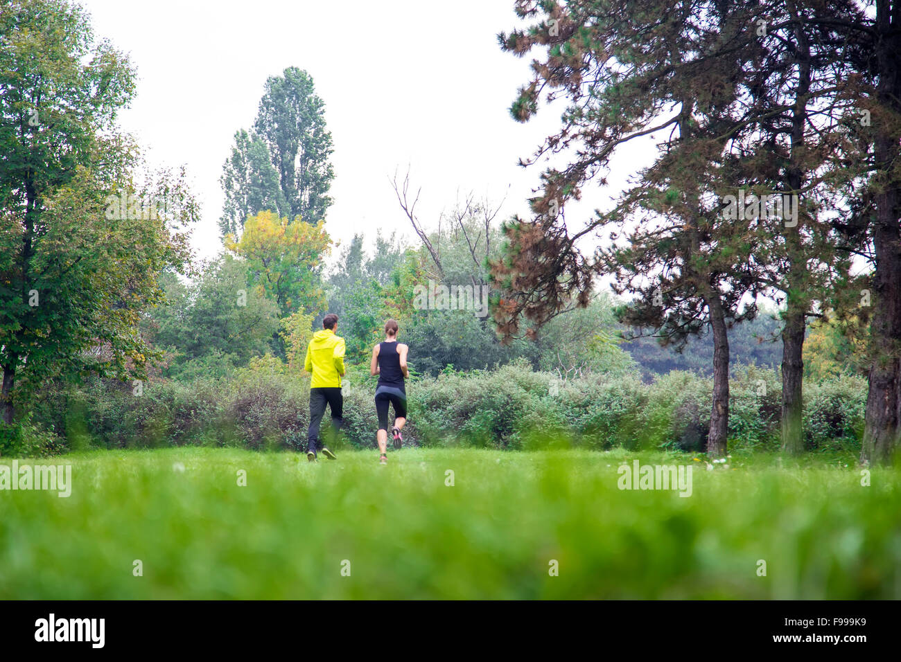 Young people running in the park Stock Photo - Alamy