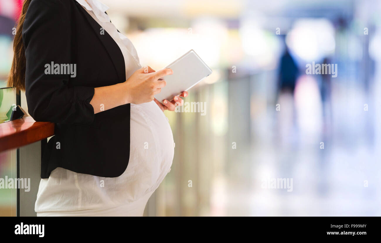 Detail of pregnant belly and digital tablet Stock Photo - Alamy