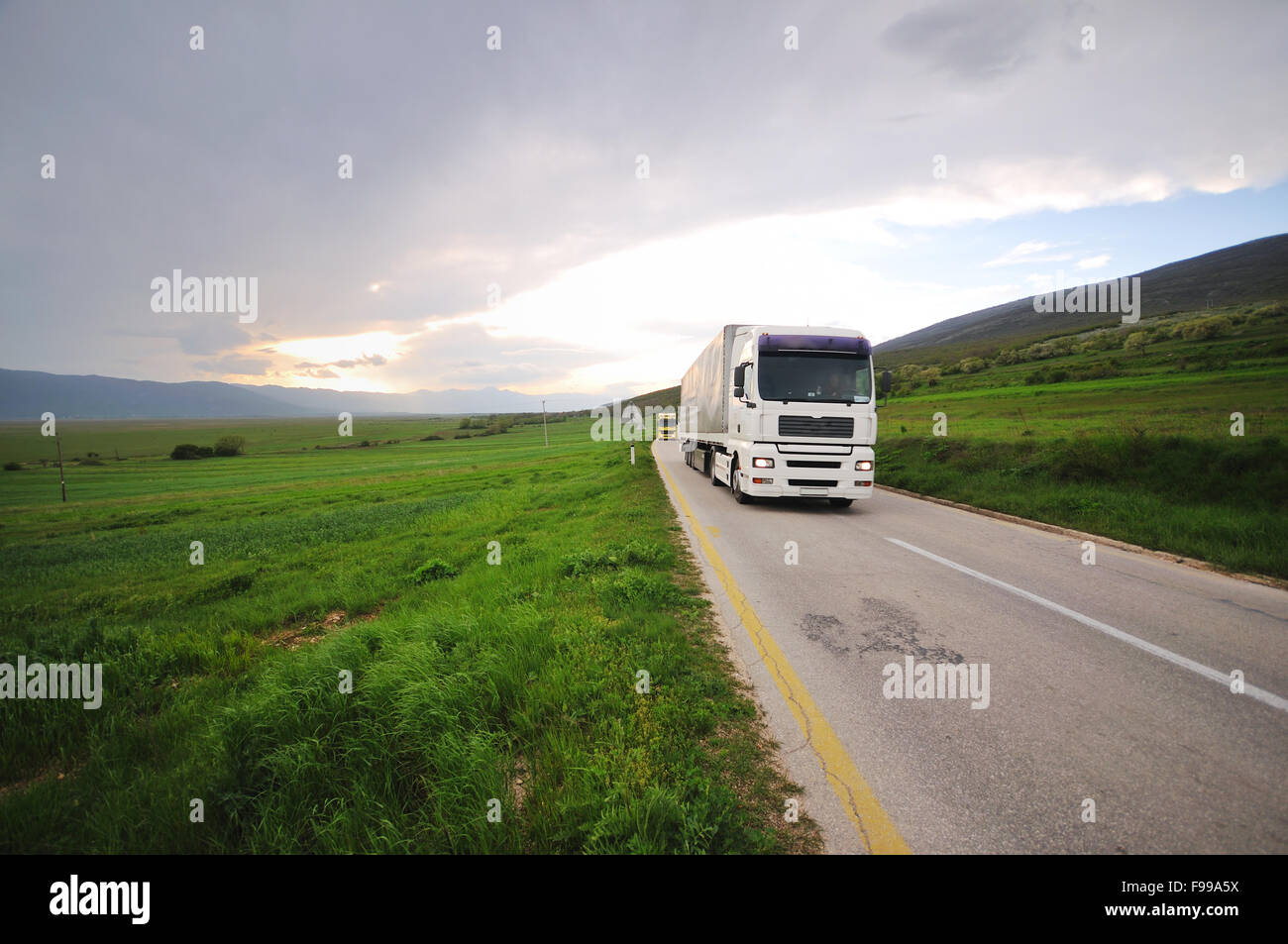 big truck drive on long country road Stock Photo - Alamy